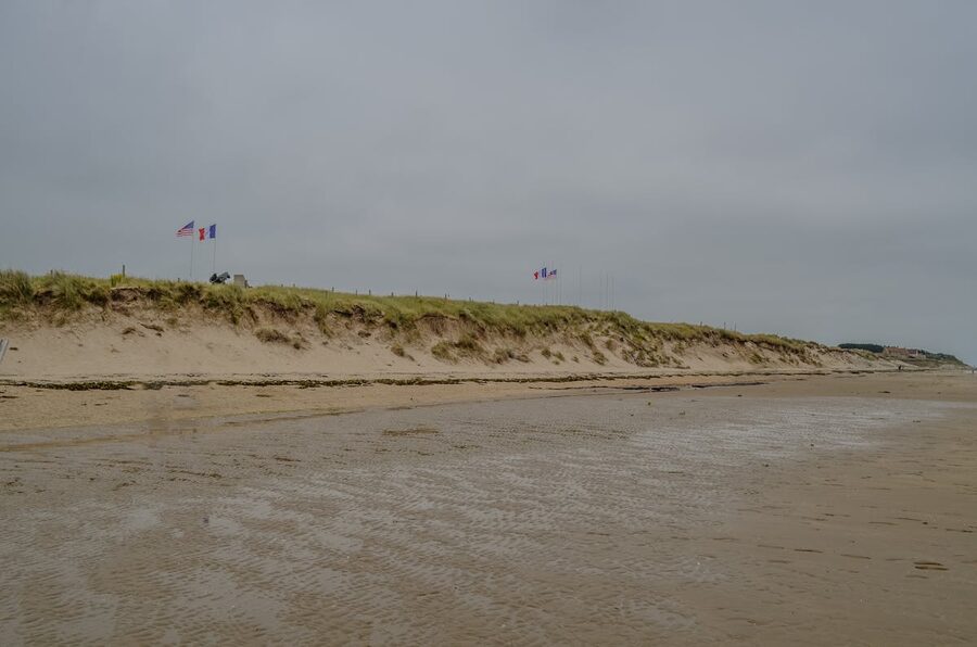 Utah Beach in Normandy with American and French flags flying over the memorial
