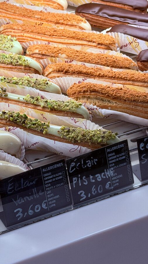 Assorted flavoured eclairs displayed in a Paris patisserie