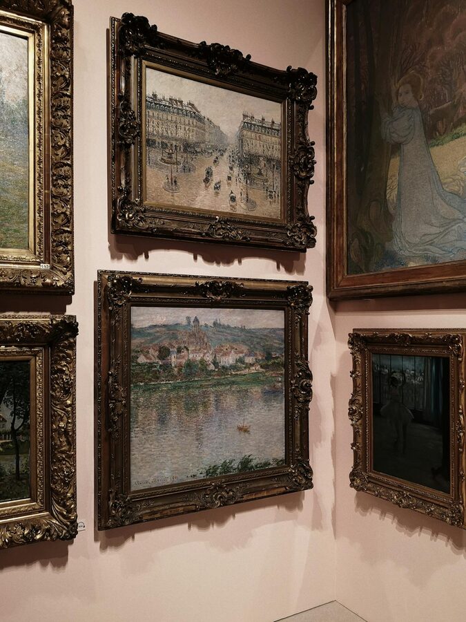 Classic paintings displayed on a gallery wall