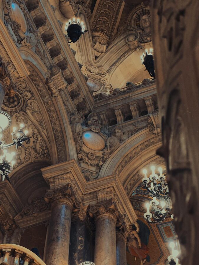 Architectural details inside the Palais Garnier with ornate arches and ceiling