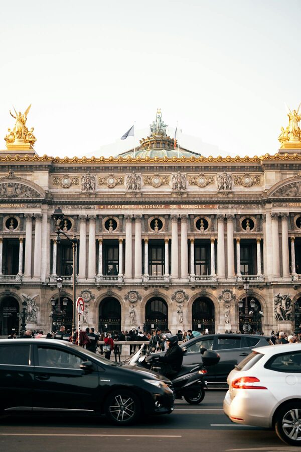 Palais Garnier exterior at dusk with street view and lights