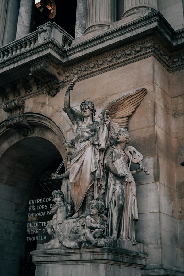 Detailed stone sculptures on the facade of the Palais Garnier