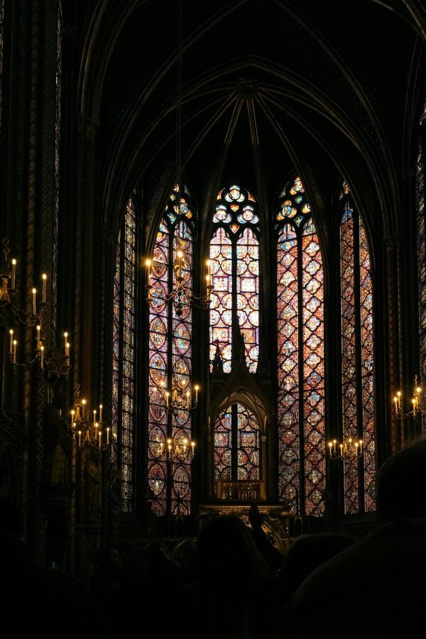 Gothic cathedral interior with stained glass and chandelier
