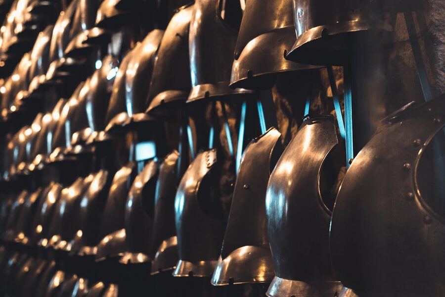 Collection of medieval knight helmets on display in a museum