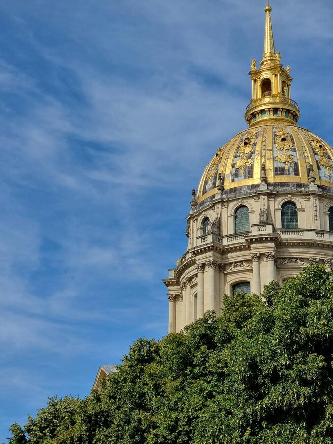 Wide view of the golden dome of Les Invalides against clear sky