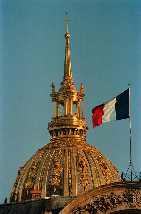 Baroque architecture of Les Invalides with French flag