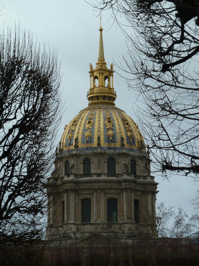 Golden dome of Les Invalides framed by winter trees in Paris