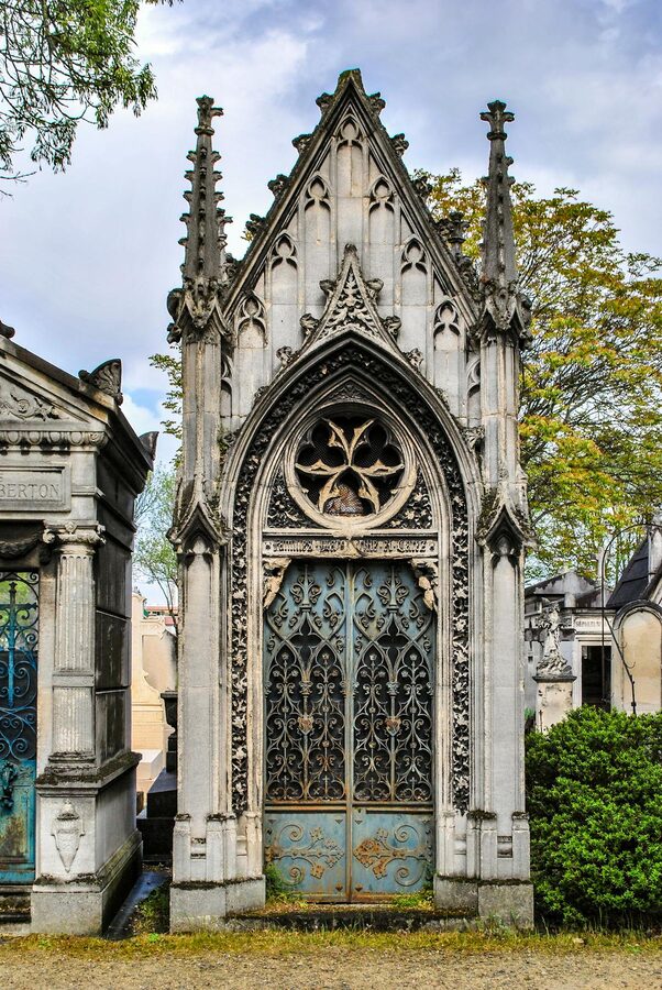 Gothic mausoleum in Père Lachaise Cemetery with ornate architecture