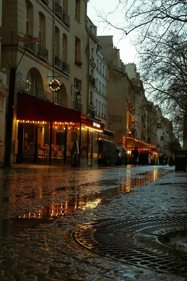 Moody evening scene of a Paris café in the Latin Quarter