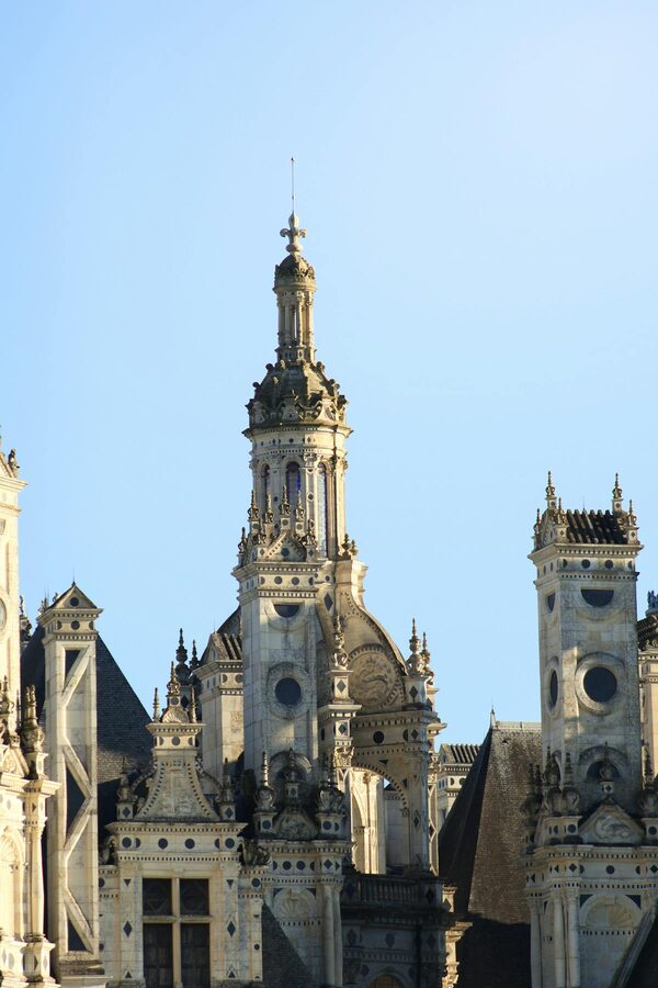 Close-up of Château de Chambord's ornate towers and chimney stacks against a blue sky