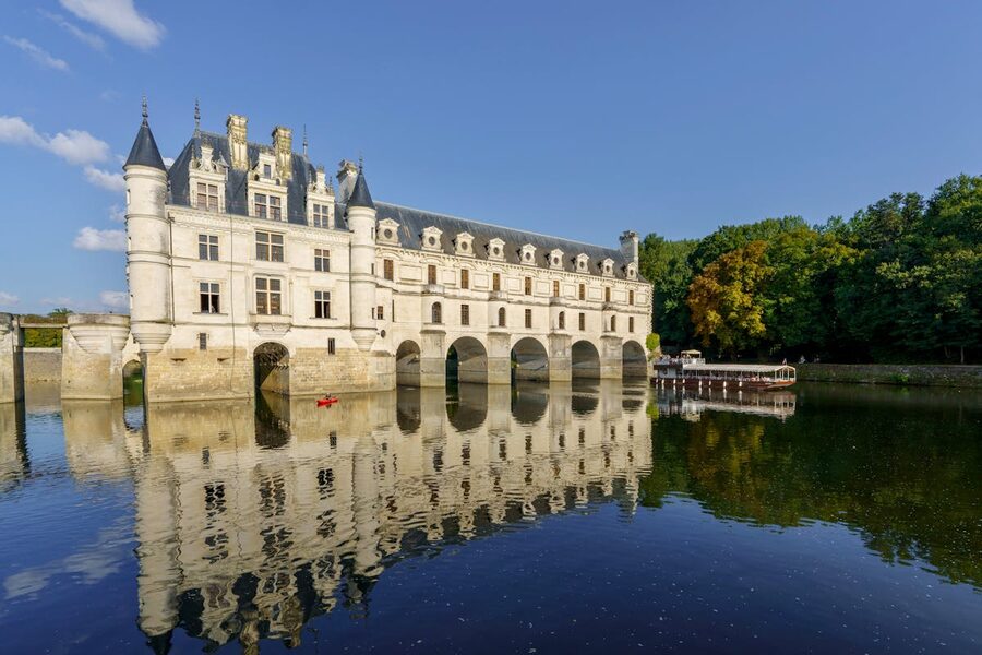 Château de Chenonceau reflecting in the River Cher with arched gallery spanning the water