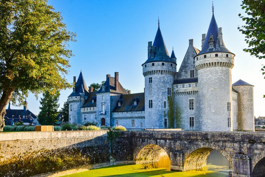 Château de Sully-sur-Loire with its medieval towers reflected in the surrounding moat