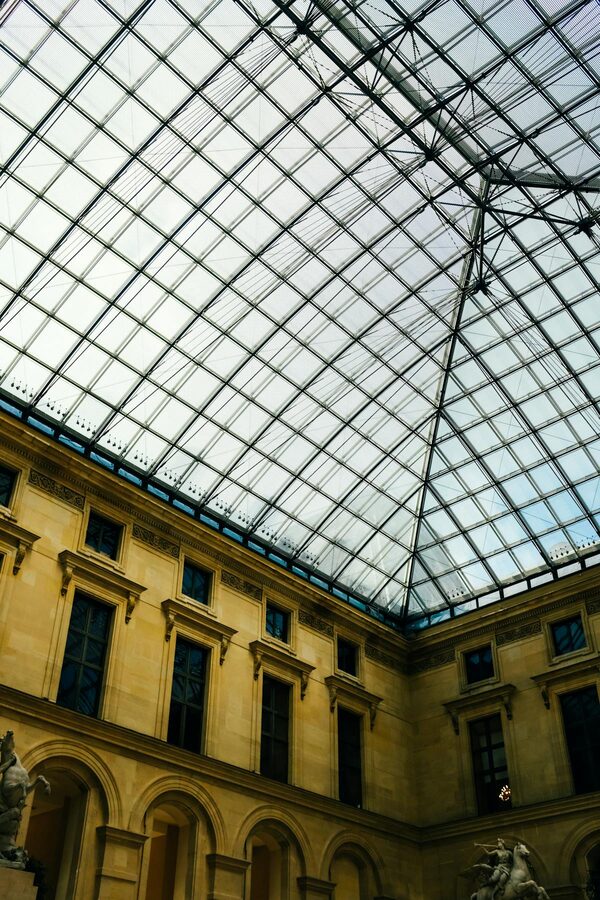 Glass ceiling architecture inside the Louvre Museum sculpture courtyard