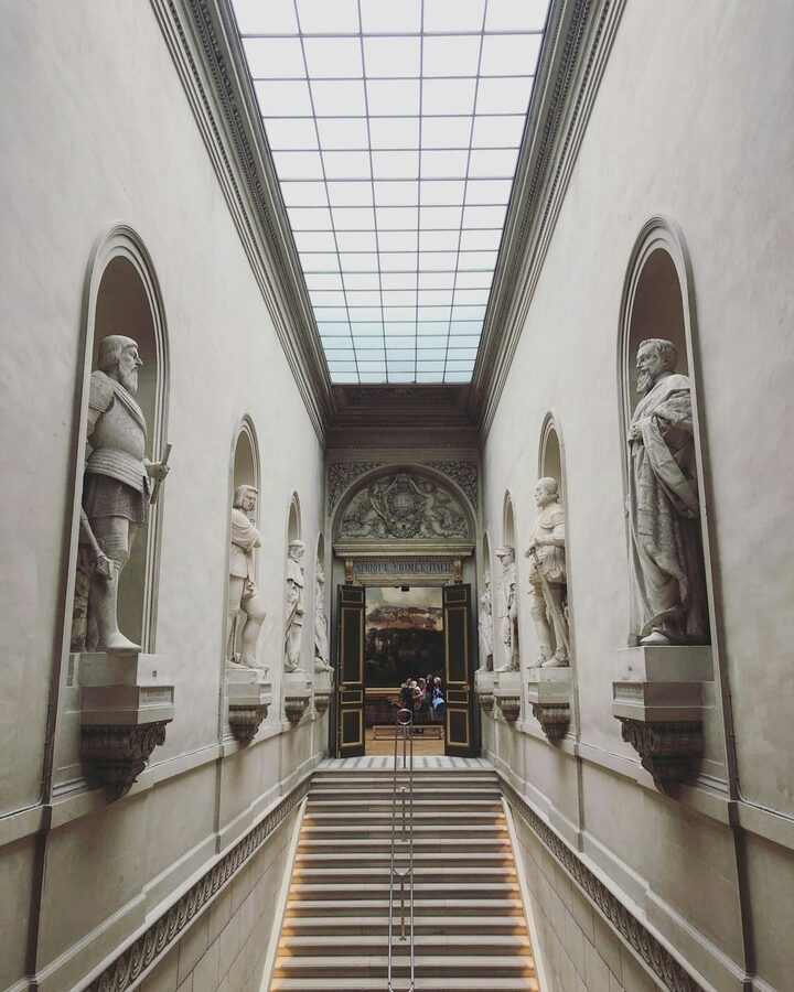 Grand staircase with classical sculptures inside the Louvre Museum