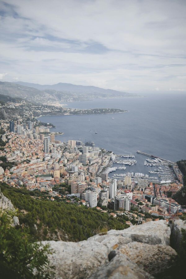 Aerial view of Monaco's coastline with dense buildings and Mediterranean Sea