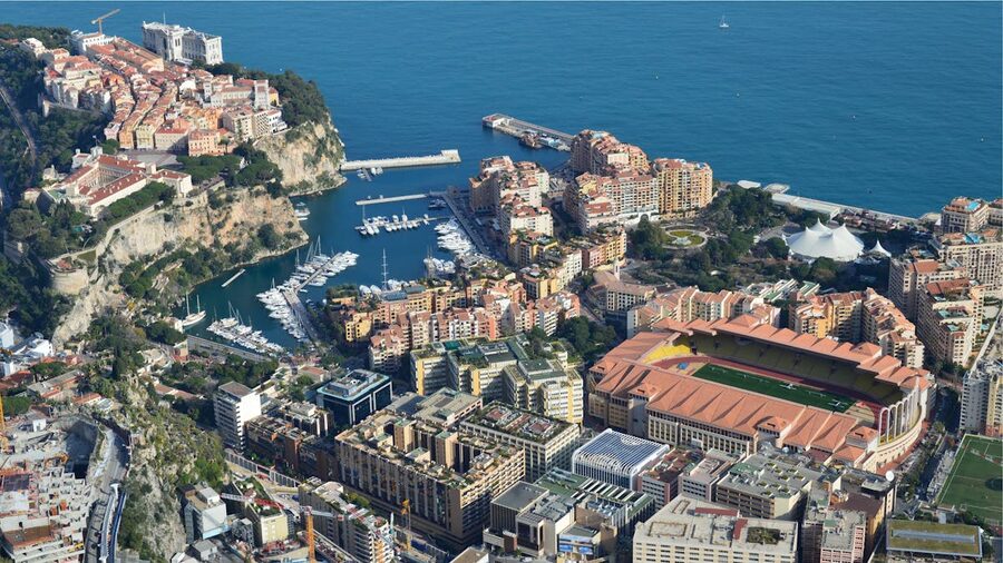 Aerial view of Monaco coastline with the Mediterranean Sea and dense city buildings