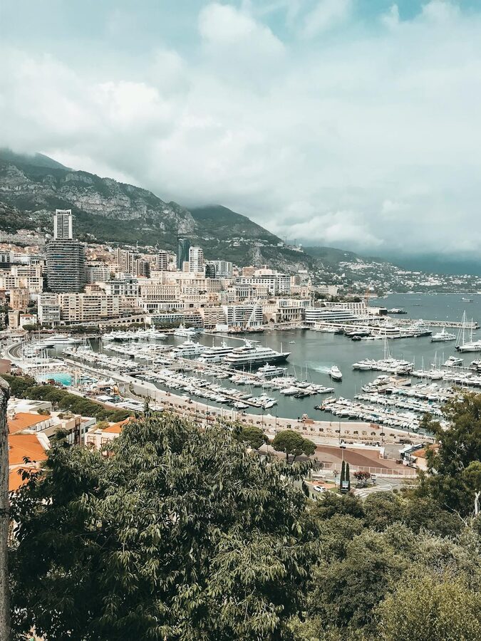 Monaco harbor with luxury yachts and city buildings rising behind