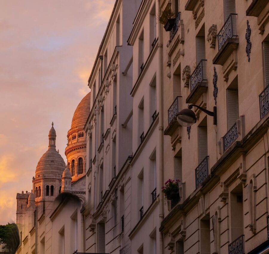 Sacré-Coeur Basilica with Parisian rooftops at sunset