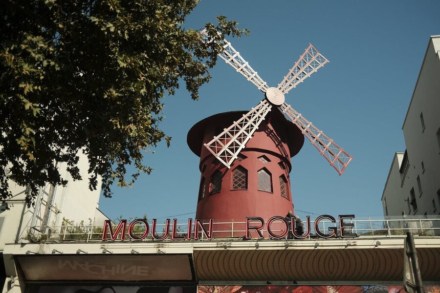 The Moulin Rouge windmill against a blue sky