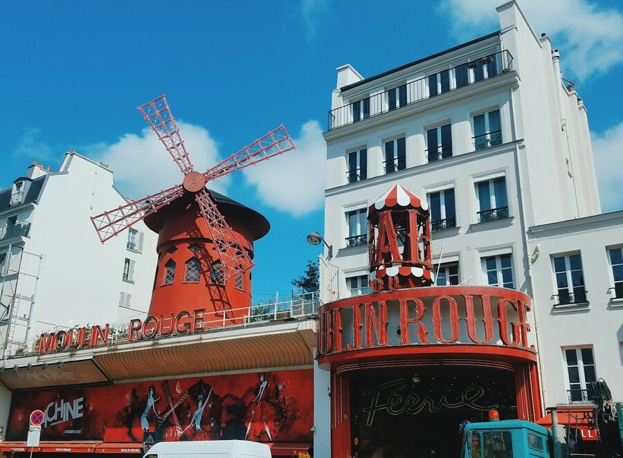 The Moulin Rouge with its red windmill against a clear blue sky