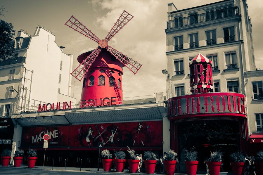 The iconic Moulin Rouge facade and windmill in Montmartre Paris