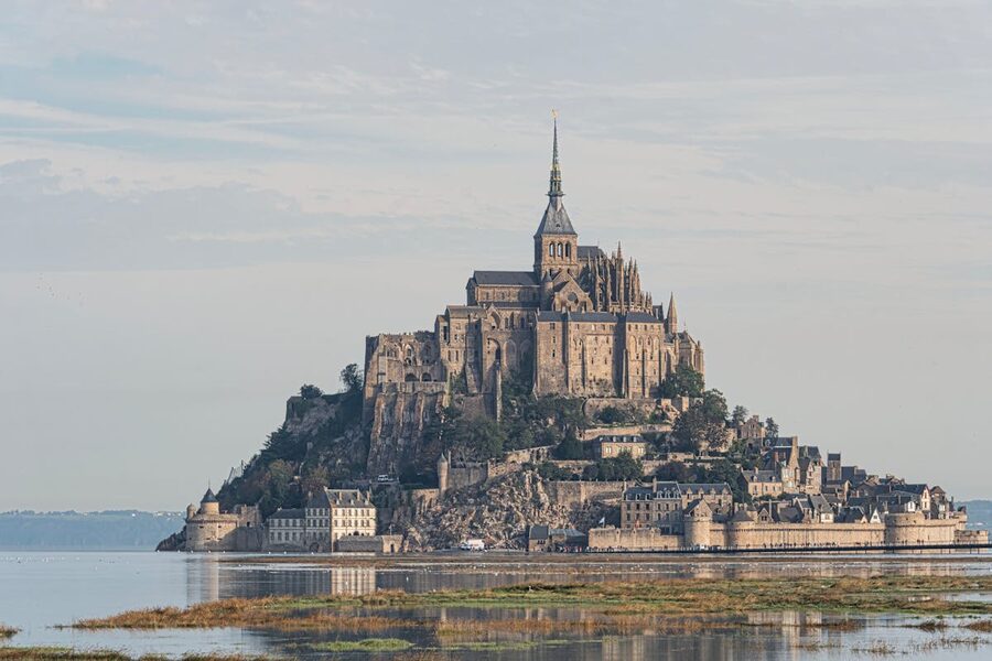 Mont Saint-Michel reflected in still water of the surrounding bay