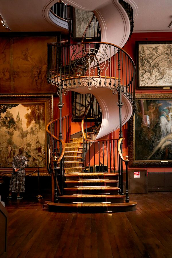 Spiral staircase inside a Paris art museum with ornate balustrades