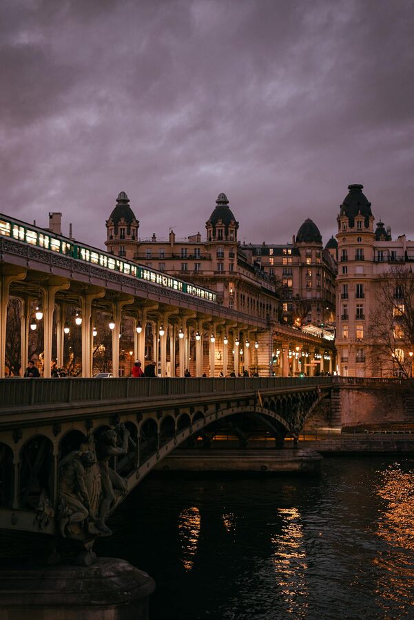Parisian bridge and architecture at dusk over the Seine