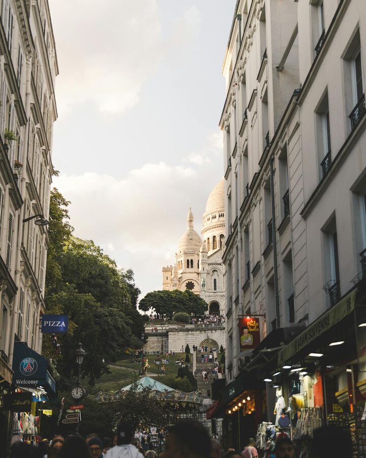 A Paris street with the Sacré-Coeur Basilica visible in the background