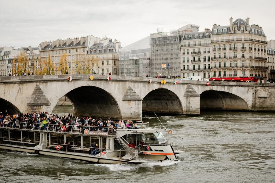 Tourists on a Seine River sightseeing boat during daytime in Paris