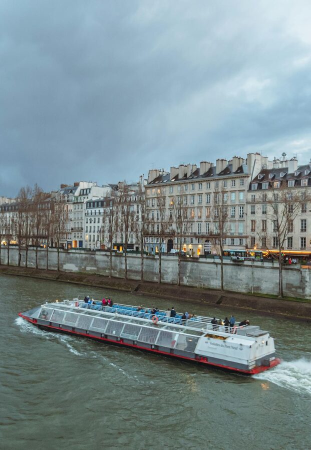 Tourist boat on the Seine River with the Eiffel Tower visible in the background