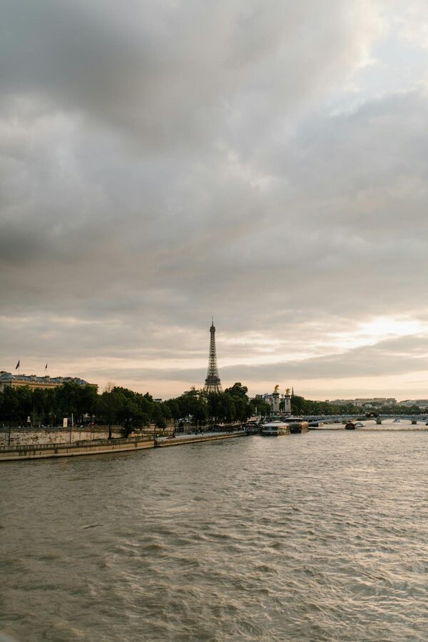 The Seine River and Eiffel Tower under a cloudy sky