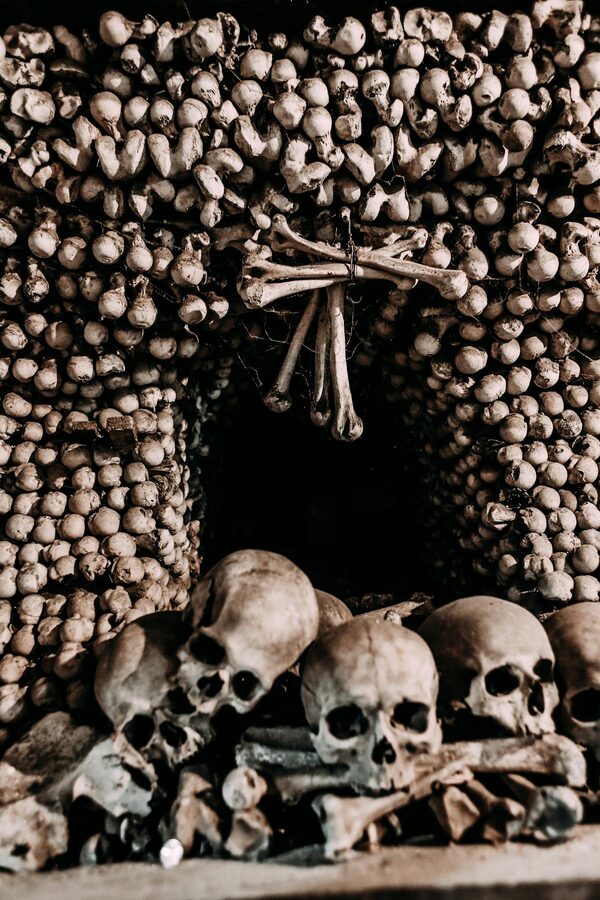 Skulls and bones in a dimly lit ossuary