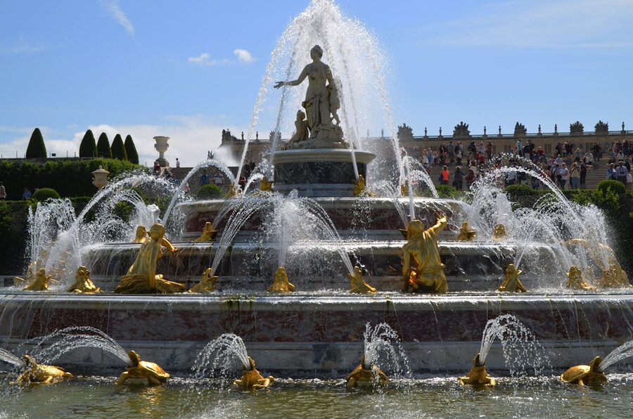 Golden statues at the Fountain of Apollo in the Versailles Palace gardens
