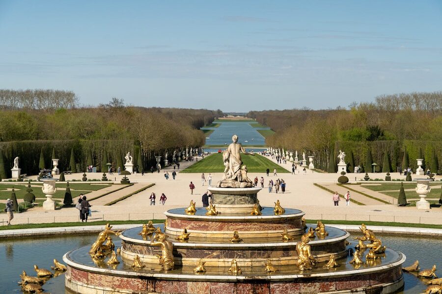 A sweeping view of the Versailles gardens with fountains and hedgerows