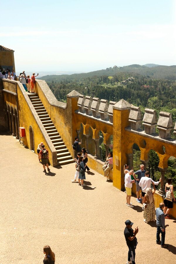 Tourists in the yellow courtyard of Pena Palace in Sintra Portugal