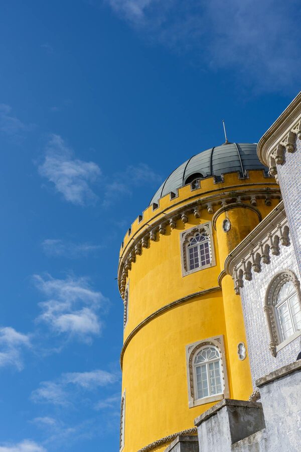 Yellow and white dome of Pena Palace against blue sky in Sintra