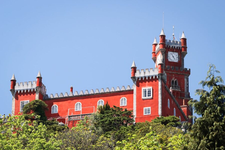 Red castle section of Pena Palace in Sintra under clear blue sky