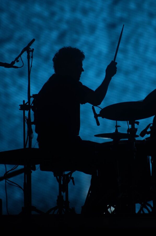 Silhouette of a drummer performing on stage