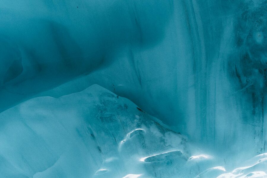 Blue ice formations stretching deep inside an Icelandic glacier cave