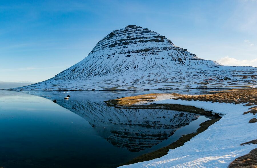 Kirkjufell mountain bathed in golden sunset light