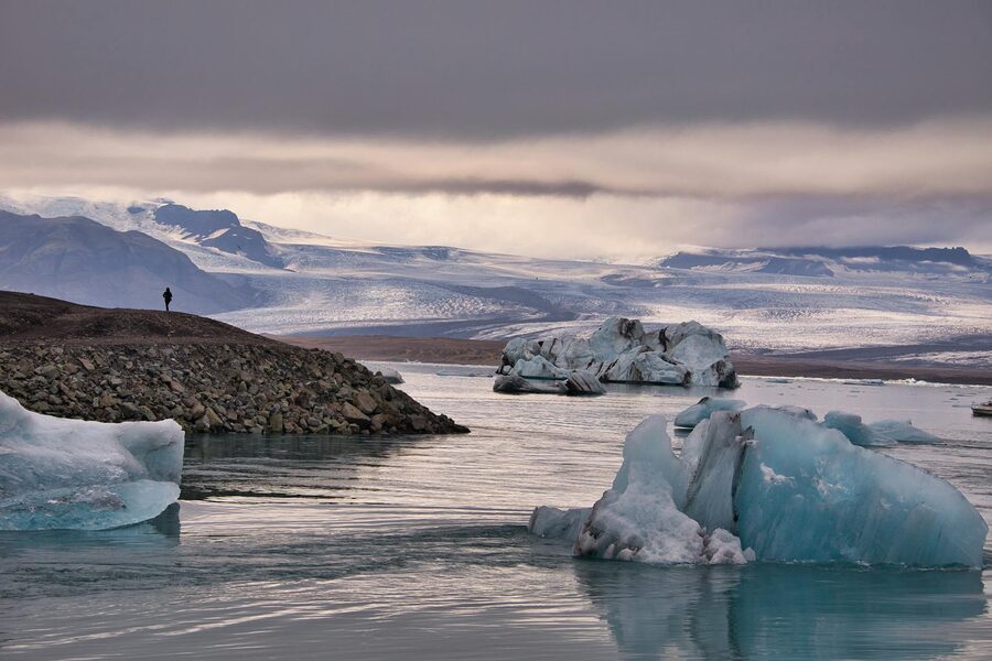 Active glacier calving blocks of ice into the lagoon below