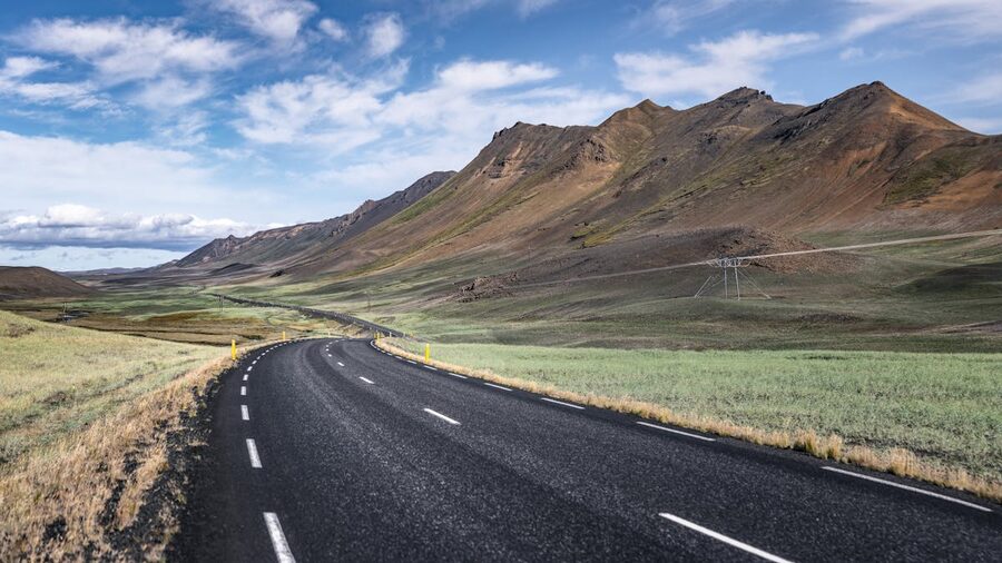 Empty road winding through Iceland mountain terrain