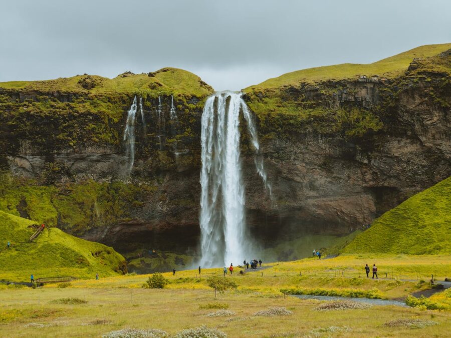 Visitors at Seljalandsfoss waterfall Iceland
