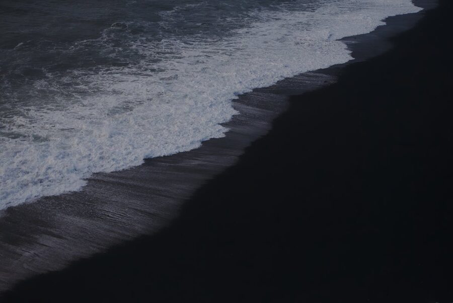 Waves crashing on black sand beach at Vik Iceland
