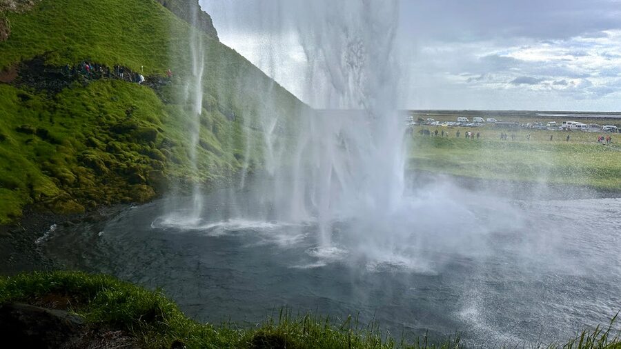 Seljalandsfoss waterfall flowing over green cliffs Iceland