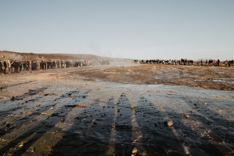 Group of travelers at geyser field in Iceland