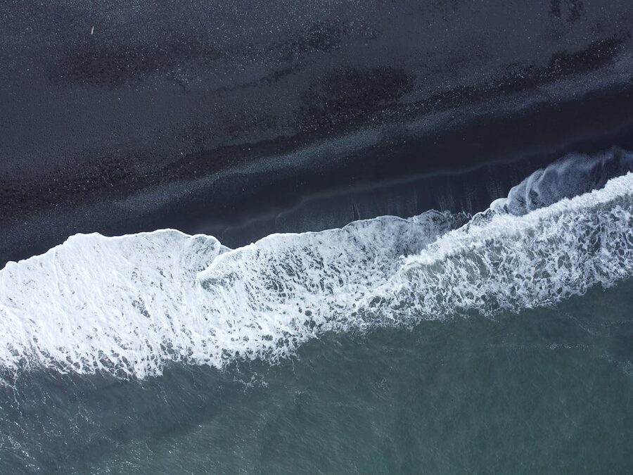 Aerial view of waves on black sand beach Iceland
