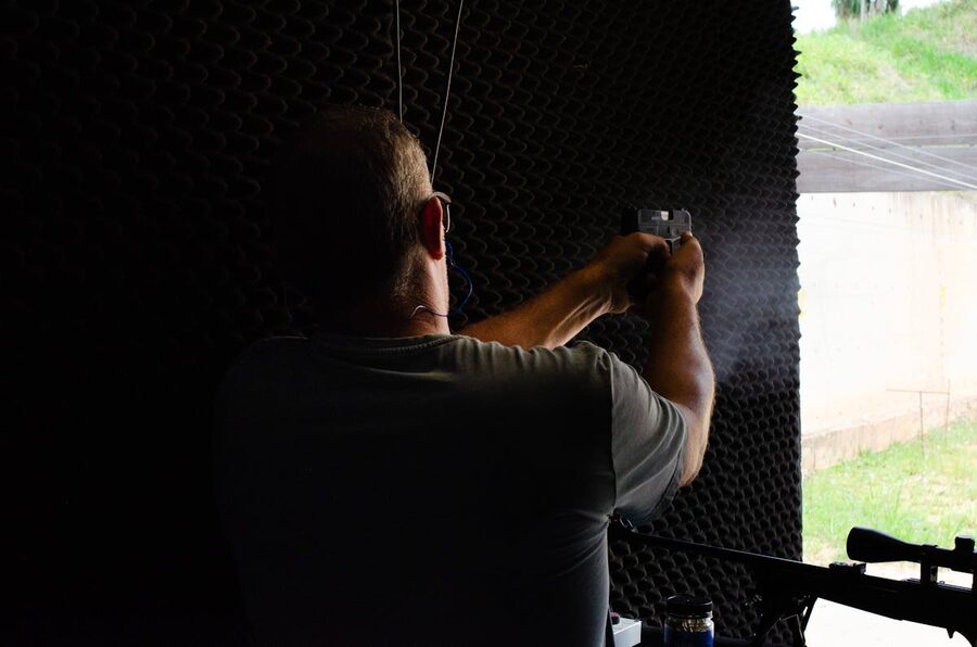 Man practicing shooting at indoor gun range