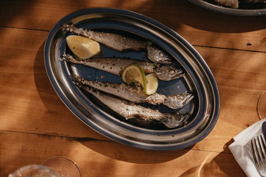 Grilled fish served with lemon on a platter
